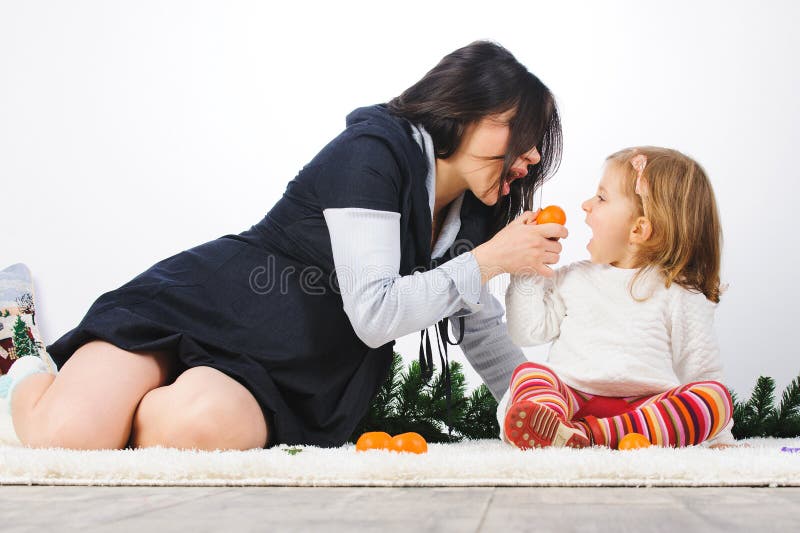 Eating Mandarin Together stock image. Image of face, family - 64924661
