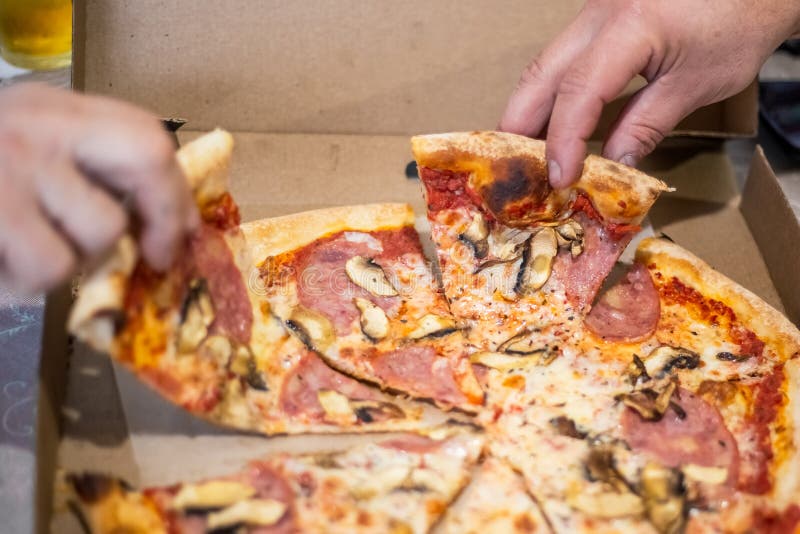 Eating Pizza. Fresh Hot Pizza in a Box, Cut into Slices Stock Image ...