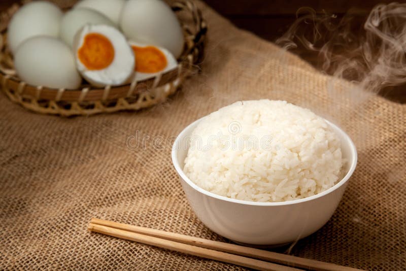 Eating Rice with Salted Eggs by Using Chopsticks on Wooden Background ...
