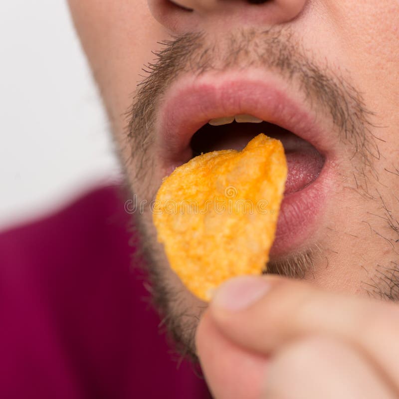 Eating Snacks. Close-up of Men Eating Potato Chip Stock Image - Image ...