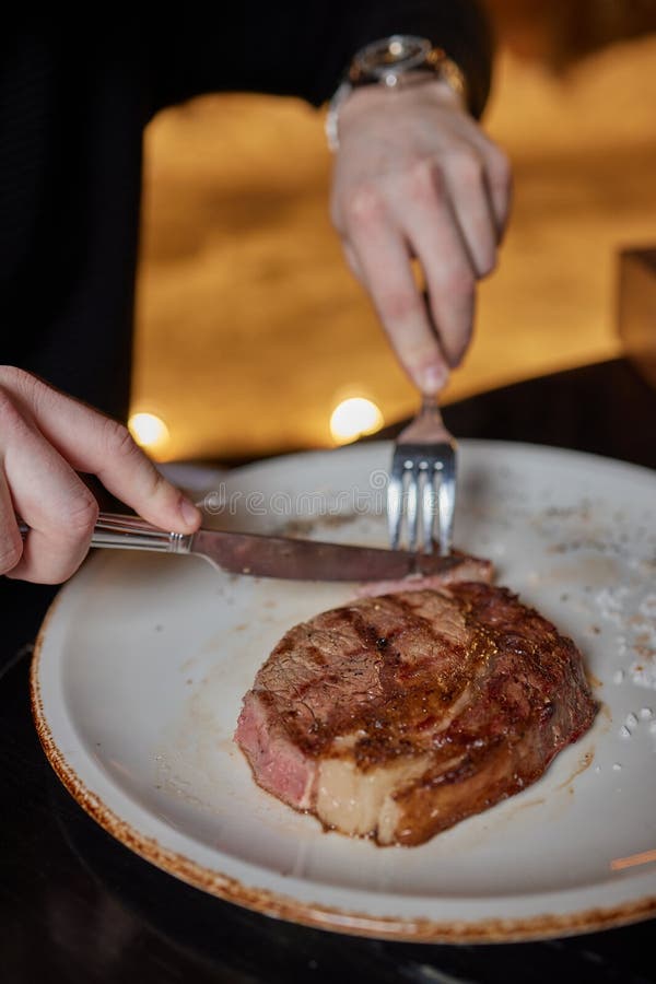 Eating Stake from Plate with Fork and Knife Man Hands. Stock Photo ...