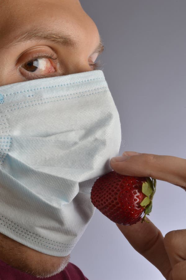 Eating a Strawberry through a Face Mask Stock Image - Image of ...