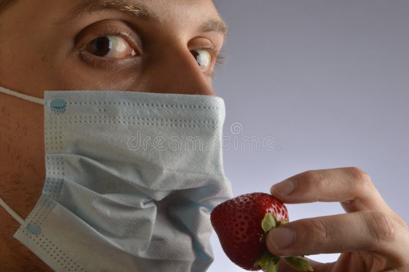 Eating a Strawberry through a Face Mask Stock Image - Image of ...