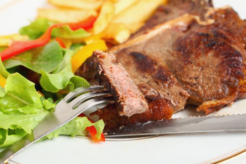 Eating T-bone steak stock image. Image of plate, meat - 18696359