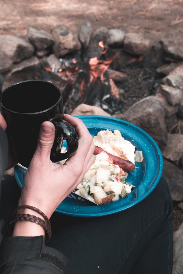 Eating a Warm Fire Cooked Breakfast while Drinking Coffee and Camping ...