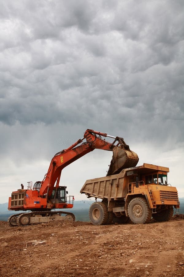 Eaxcavator loading truck stock photo. Image of tractor - 8752676