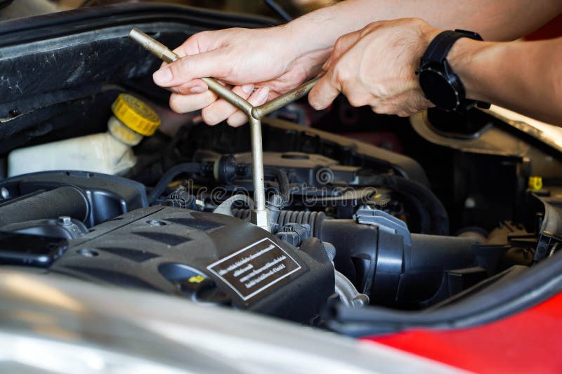 Mechanic Works on the Engine of the Car in the Garage. Repair Service ...