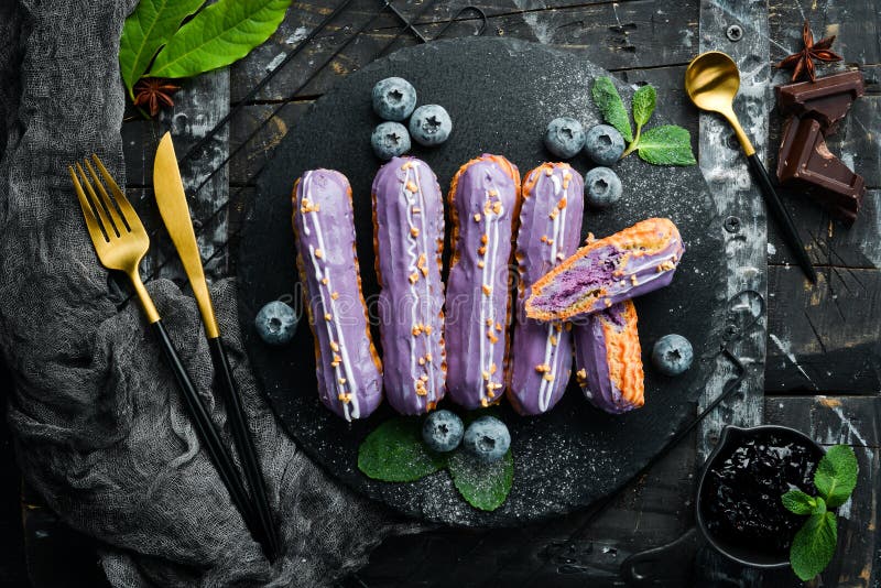 Eclair with Blueberry Cream. Blueberry Dessert on a Black Stone Plate ...