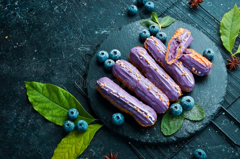 Eclair with Blueberry Cream. Blueberry Dessert on a Black Stone Plate ...