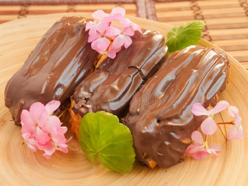 Eclair with Chocolate Custard Decorated with Pink Flowers Stock Photo ...