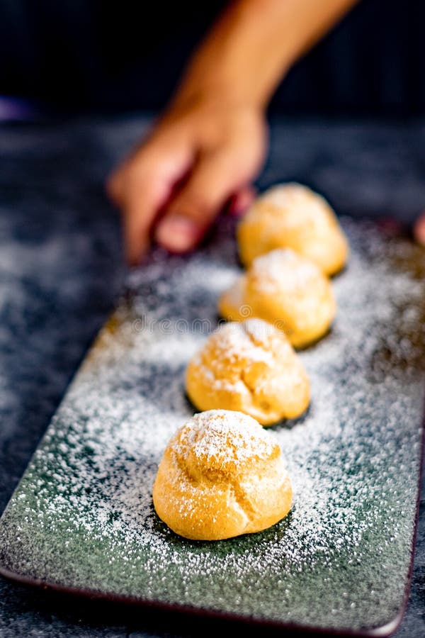 Eclair, Choux Filled Vanilla Custard Cream and Dusted with Icing Stock ...