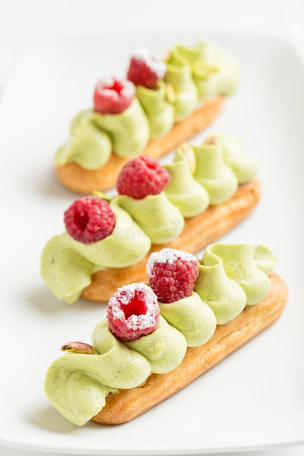 Eclair Com Creme E Morangos Do Pistache Foto de Stock - Imagem de ...
