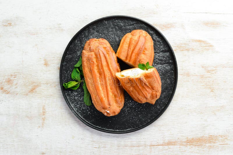 Eclair with cream. Sweets stock image. Image of view - 195931295