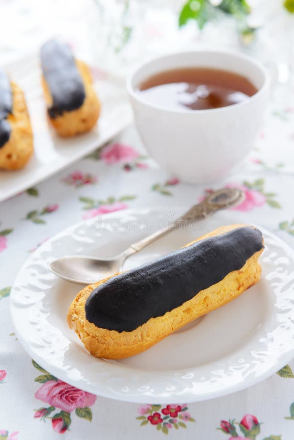 Eclair with Custard and a Cup of Tea Stock Photo - Image of bakery ...
