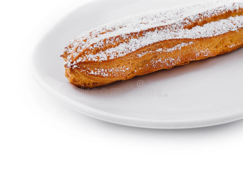 Eclair with Powdered Sugar on a Plate Stock Photo - Image of sugar ...