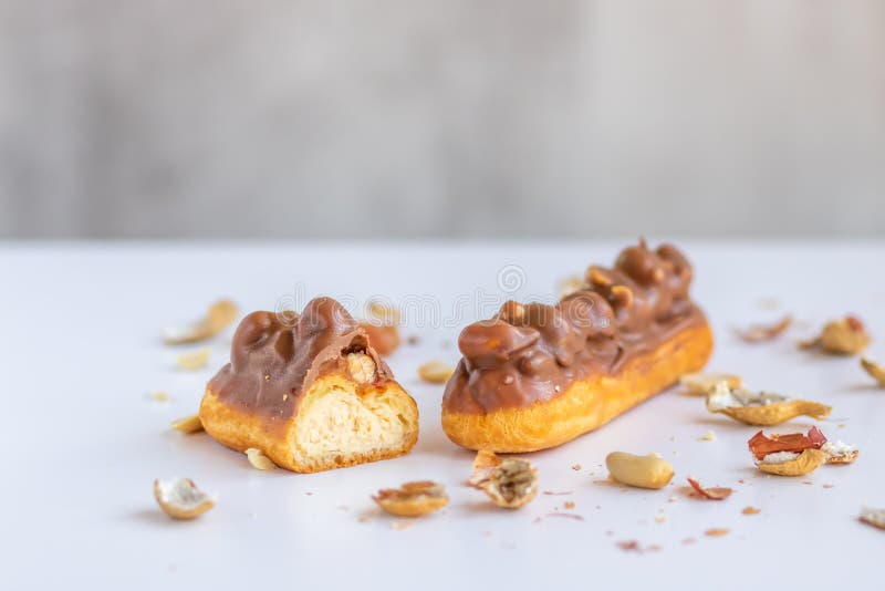 Eclair with Vanilla Cream, Peanuts and Chocolate. Stock Image - Image ...