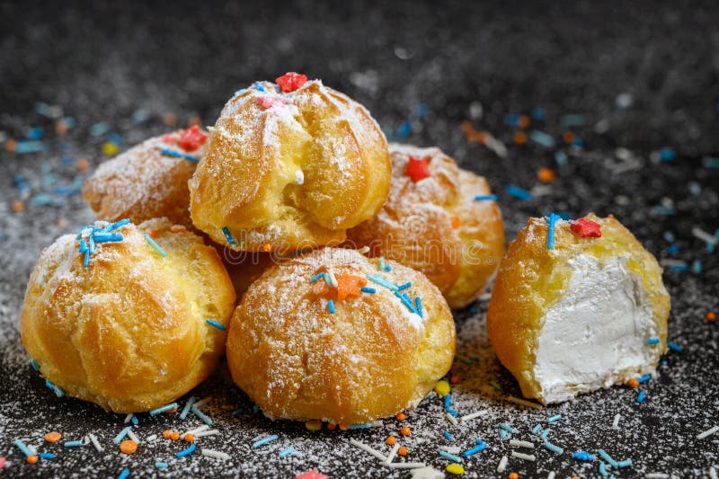 Eclairs Dusted With Multicolored Sprinkles And Powdered Sugar Stock ...