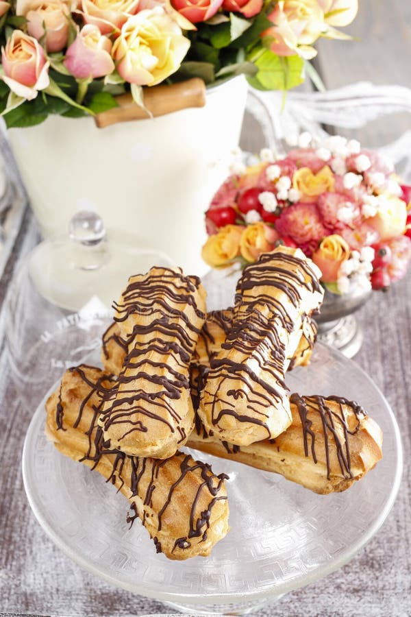 Eclairs on cake stand stock photo. Image of pastry, filled - 45748172