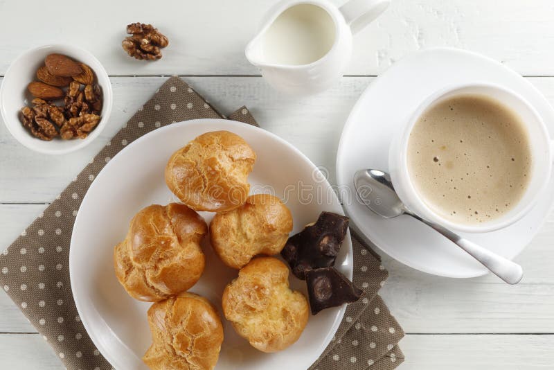 Eclairs with Chocolate, Cappuccino and Milk. Sweet Breakfast Stock ...