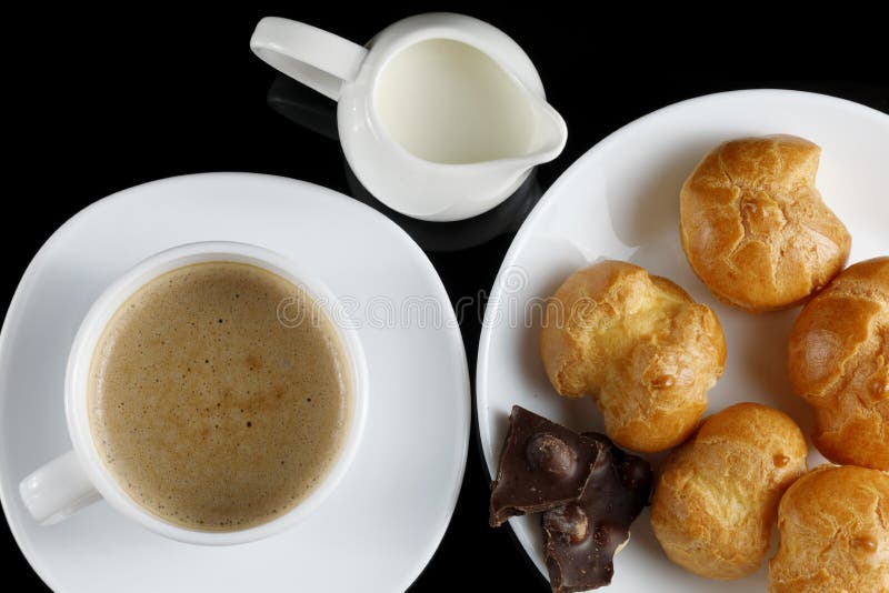 Eclairs with Chocolate, Cappuccino and Milk. Sweet Breakfast Stock ...