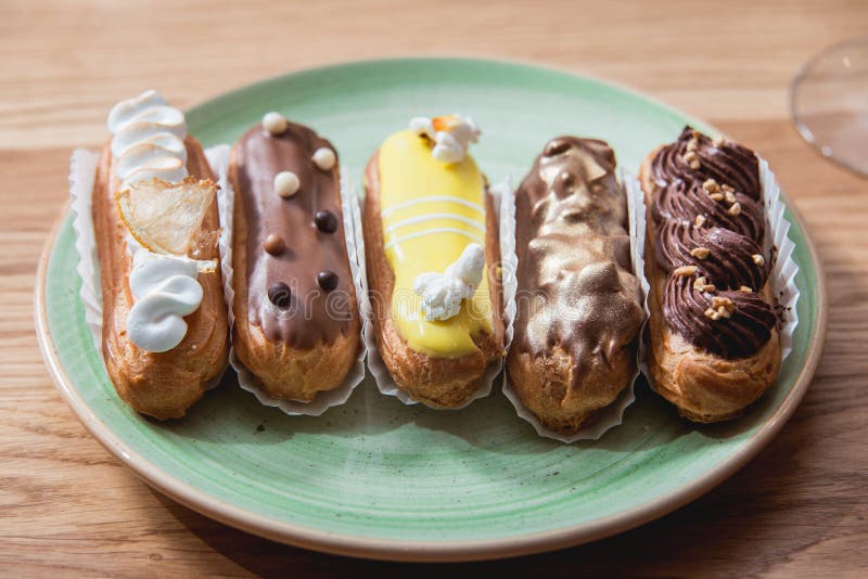 Eclairs with Different Ganache and Icing with Different Toppings Stock ...