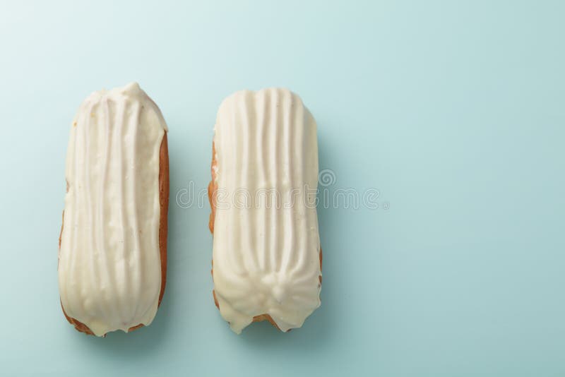 Eclairs with White Chocolate Glaze on Duck Egg Blue Background Stock ...