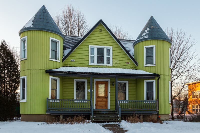 Eclectic-style Bright Green Clapboard House with Two Symmetrical Round ...