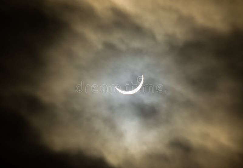 A Waxing Crescent Shaped Moon in an Eclipse Behind Dark Clouds a Stock ...