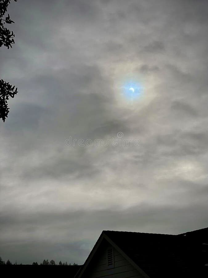 Eclipse of the Sun by the Moon Showing through Dark Clouds. Stock Photo ...
