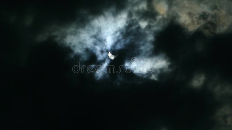The Eclipse of the Sun in the Sky. the Eclipse through the Cloud Stock ...