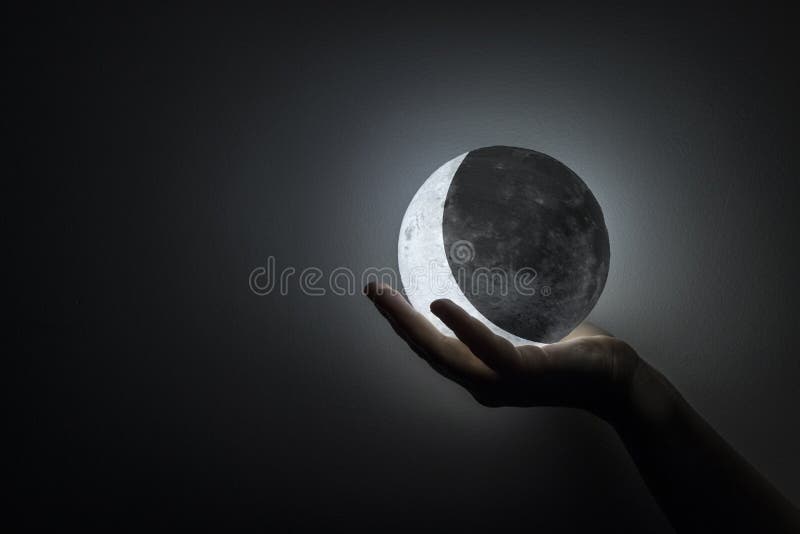 Eclipsed moon in the hand stock image. Image of design - 184630853