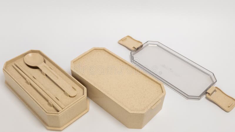 Eco-friendly Lunch Box with Utensils and Clear Lid on a White Surface ...
