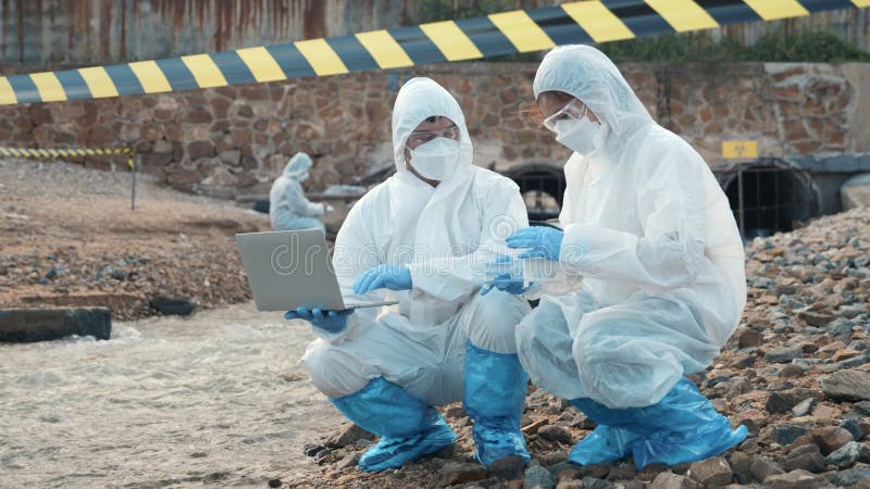 Ecologist Sampling Water from the River with Test Tube and Save Data To ...