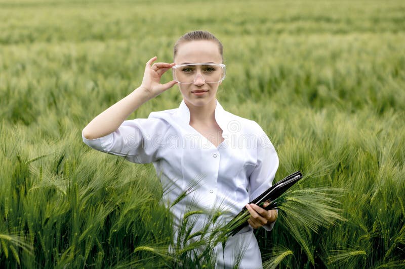 Ecologist in a White Coat and Glasses Examining Plants Stock Image ...