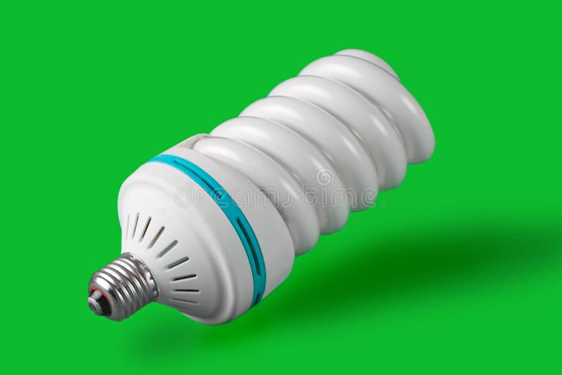 Economic Light Bulb Standing on Green Background Stock Photo - Image of ...