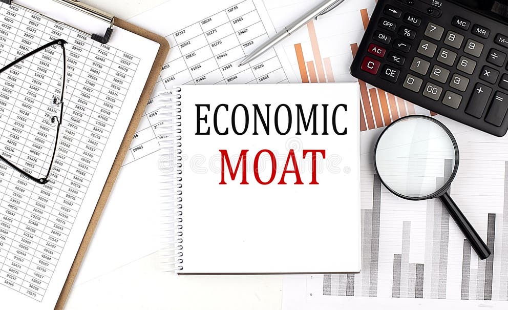 ECONOMIC MOAT Text on Notebook with Clipboard and Calculator on a Chart ...