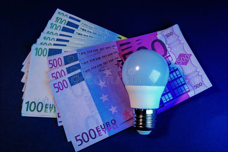Economical Light Bulb on Top of 500 and 100 Euro Banknotes Stock Image ...