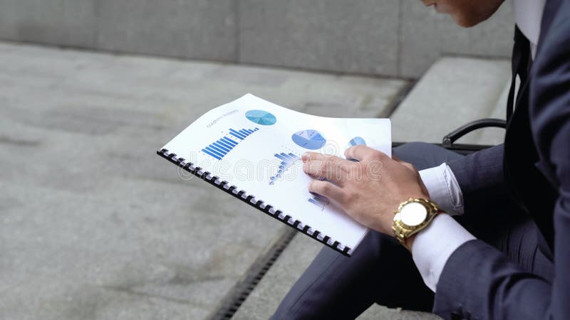 Economist Analyzing Graphs and Charts before Important Meeting ...