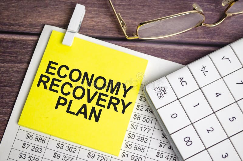 ECONOMY RECOVERY PLAN CONCEPT. Text on Business Paper on Office Table ...