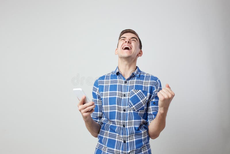 Ecstatic Full of Energy Guy Dressed in a White T-shirt and Jeans Shouts ...