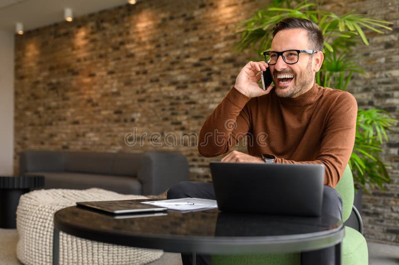 Ecstatic Male Professional Discussing Over Phone Call while Using ...
