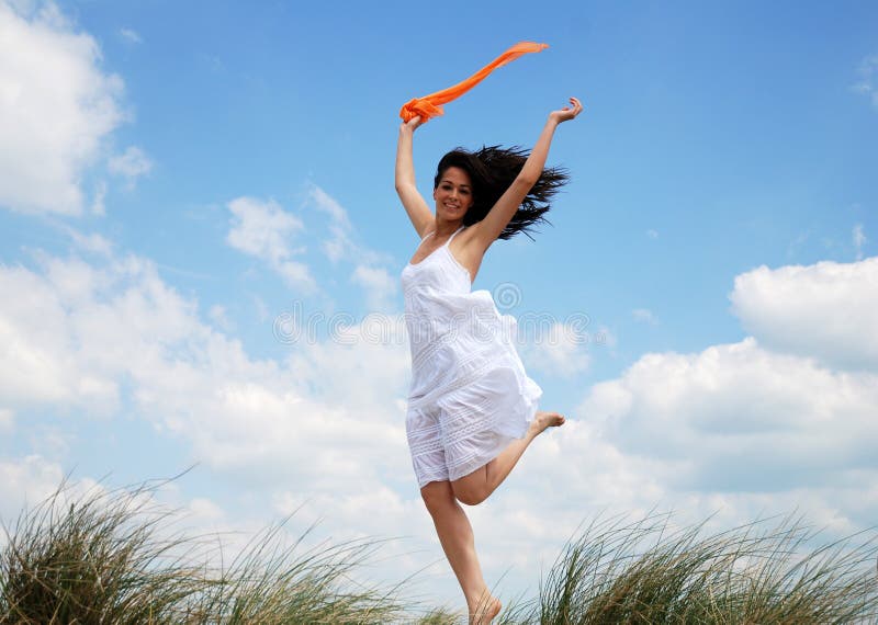 Ecstatic woman jumping stock photo. Image of jump, brown - 9831690