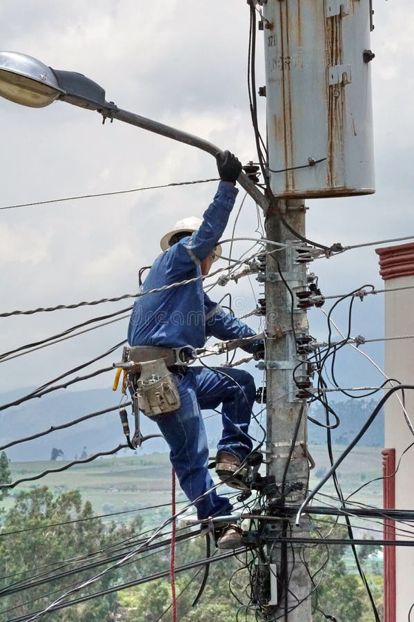 Lineman on a power pole editorial photography. Image of pylon - 158016587