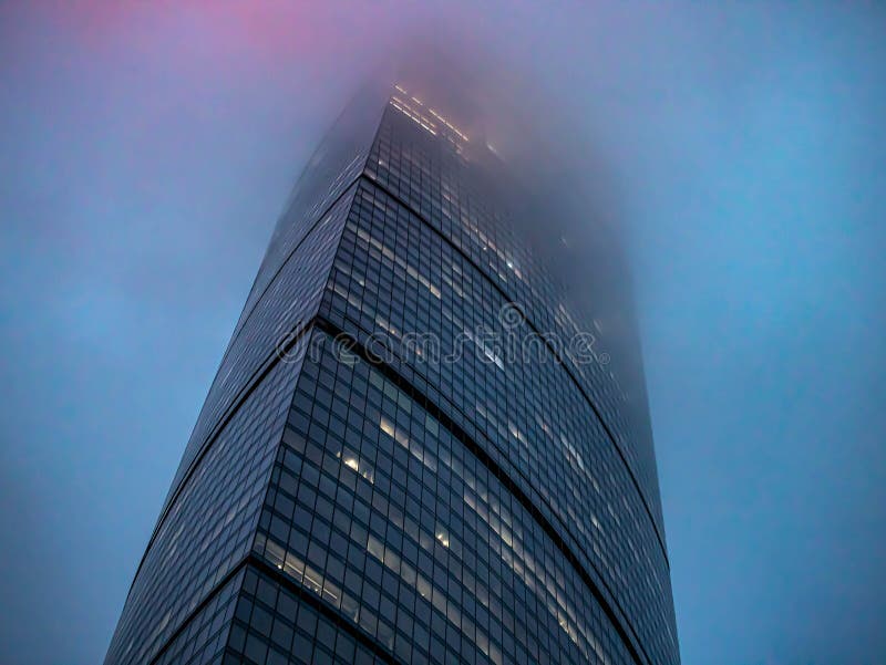 The Edge of a Rounded Tall Building Whose Top is Hidden in the Fog ...