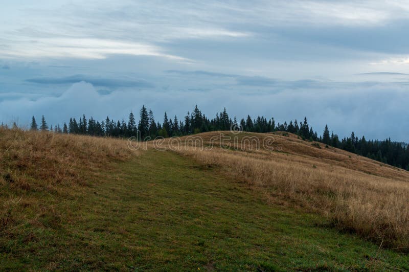 At the Edge of the Summit. at the Height of the Clouds. Large Clouds ...