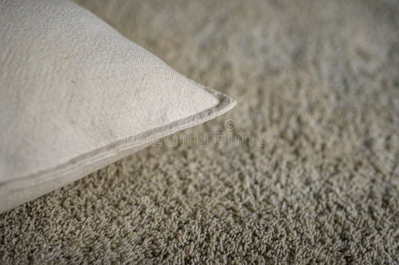 Edge Tip View of White Cushion on Beige Carpet. Stock Photo - Image of ...