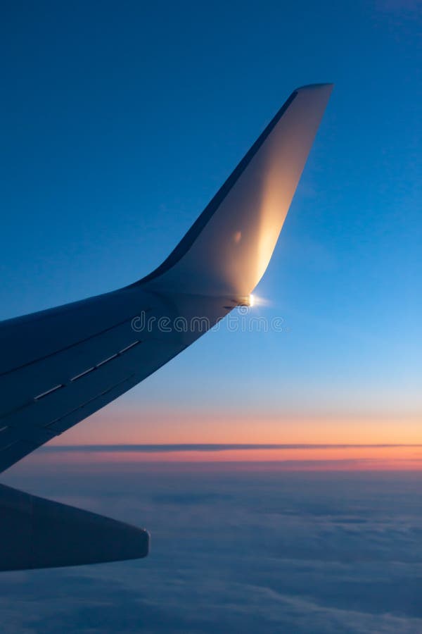 Edge of a Plane Wing Above the Sunset Clouds Stock Image - Image of ...