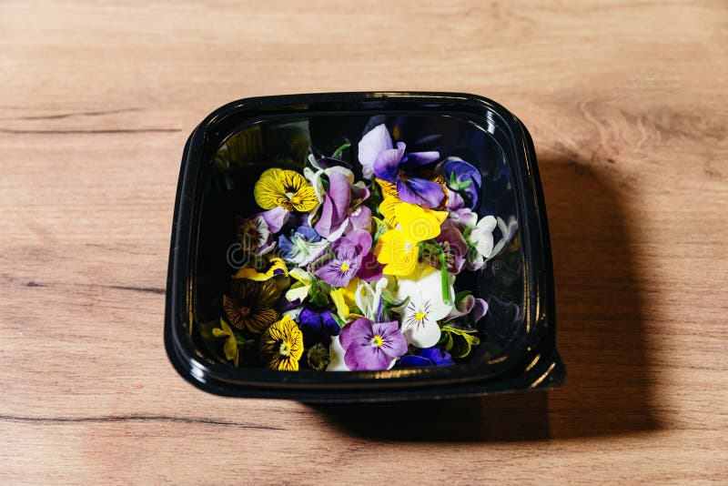 Edible Flowers in Plastic Container on Table Stock Image - Image of ...