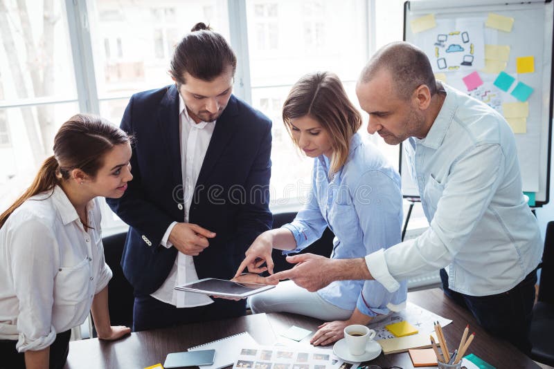 Editors Using Digital Tablet in Meeting Room Stock Photo - Image of ...