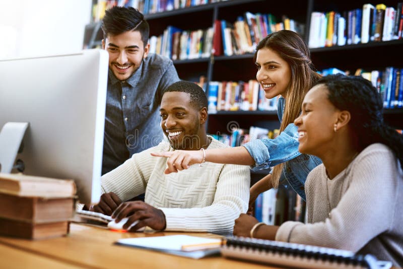 Education in Action. a Group of Young Students Using a Computer ...